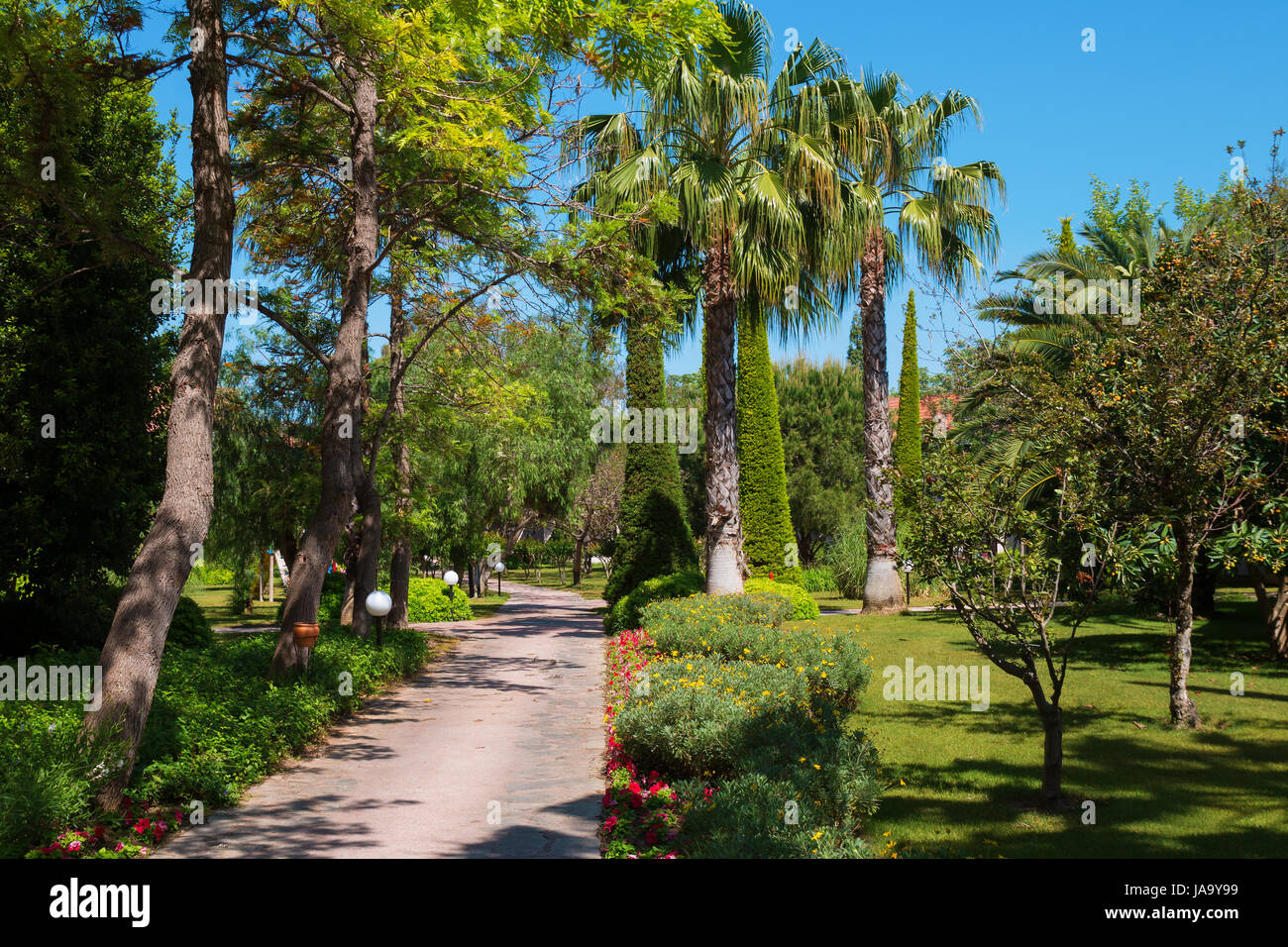 Quiet walkway into tropical garden Stock Photo - Alamy