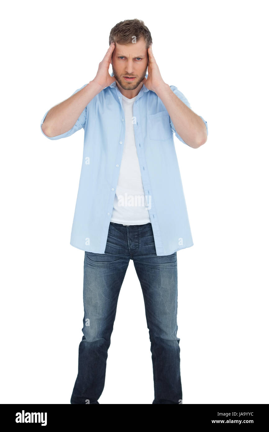 Handsome model with headache looking at camera against white background ...