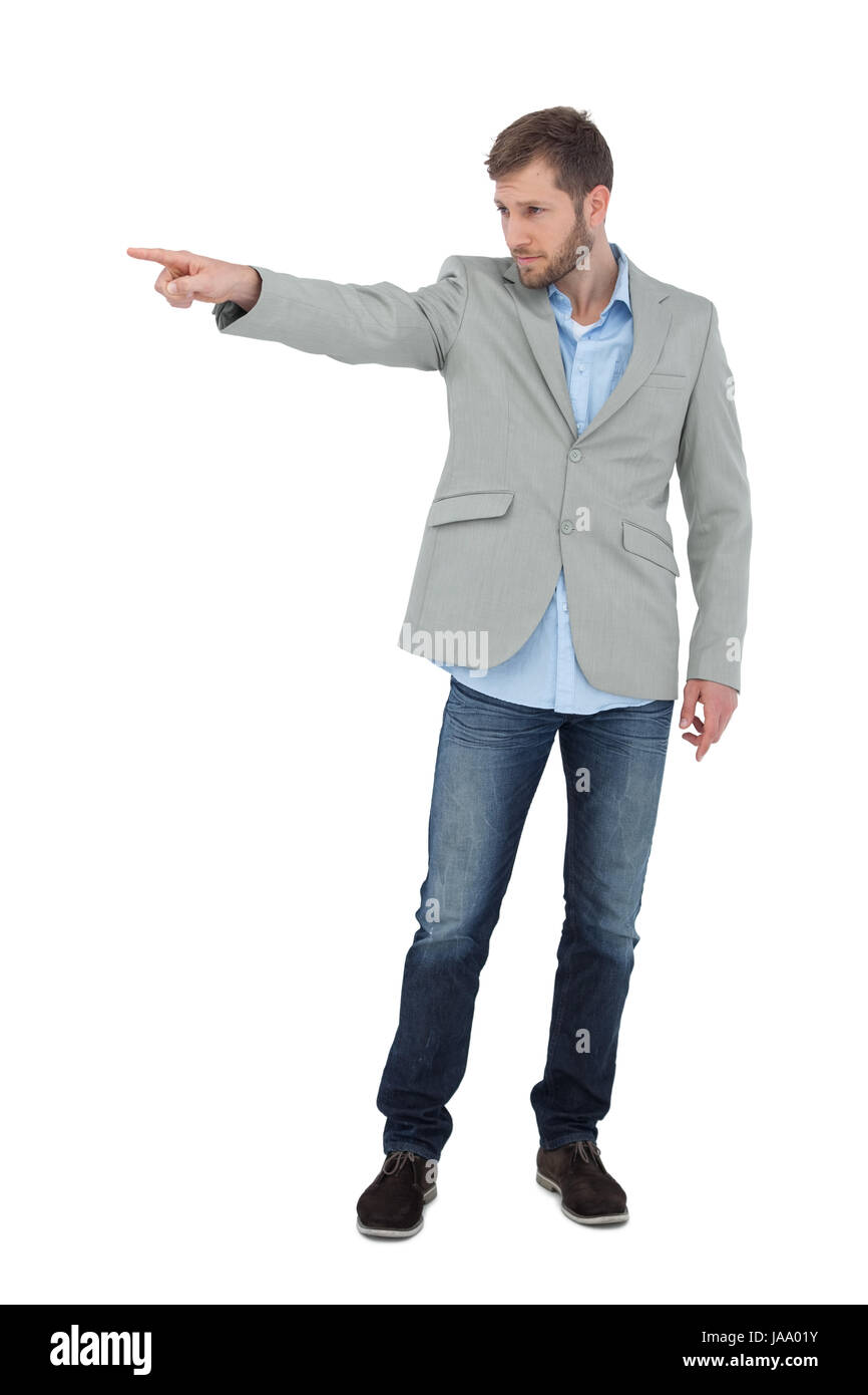 Trendy model pointing to something on white background Stock Photo - Alamy