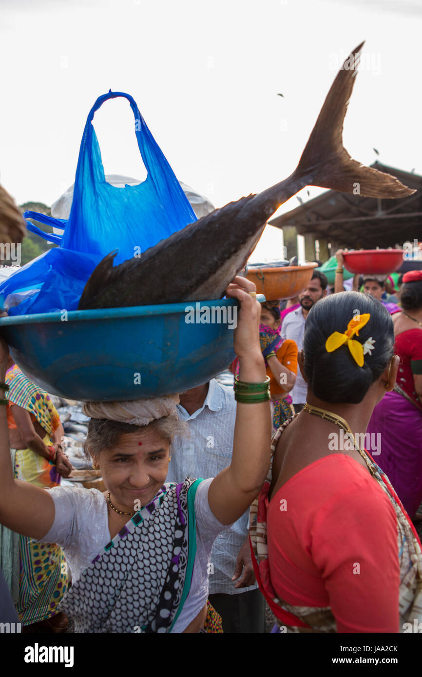A woman carrying a huge fish in a bowl on her head, Sassoon dock fish ...