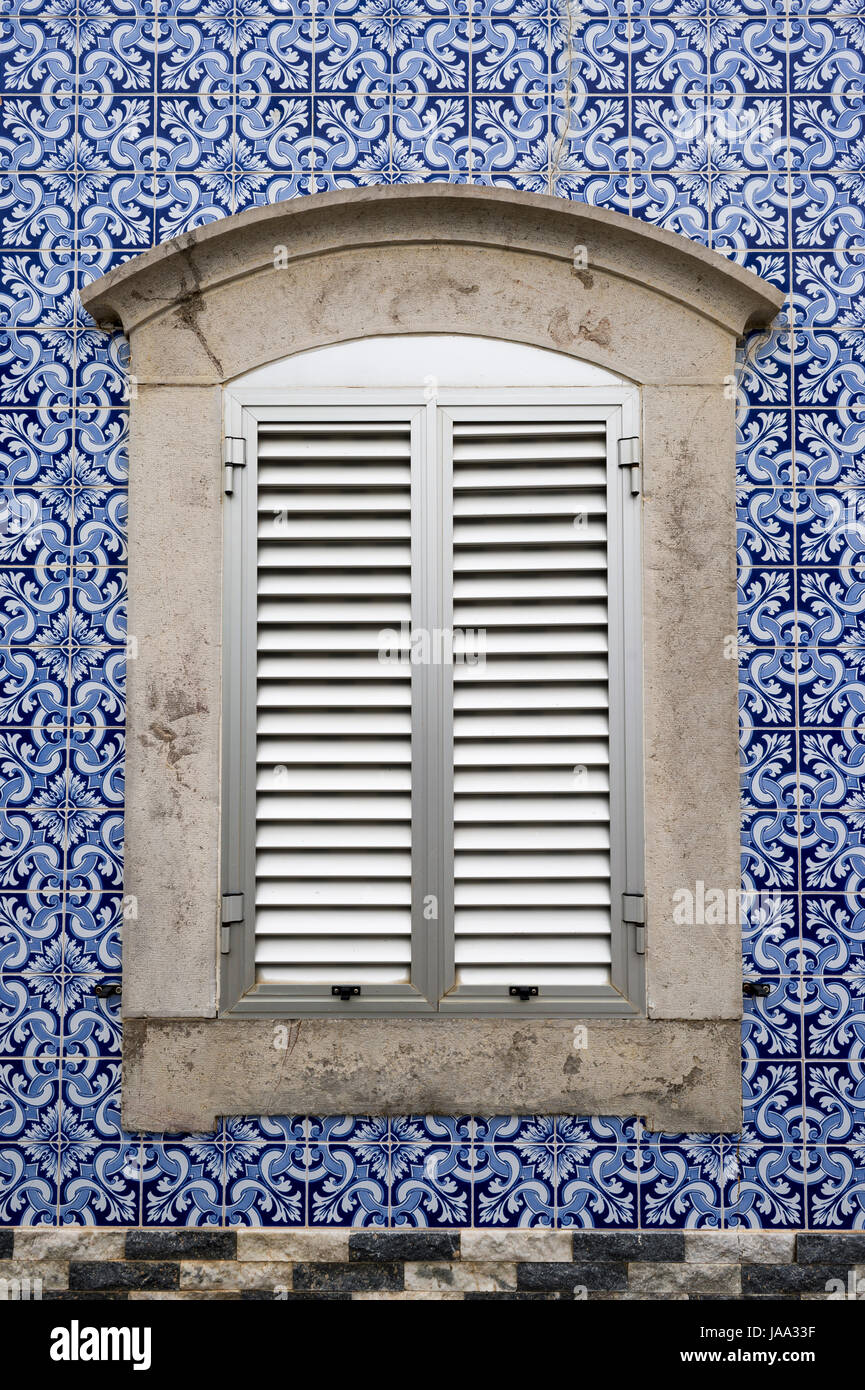 traditional Portuguese tiles on the exterior wall of a building with a ...