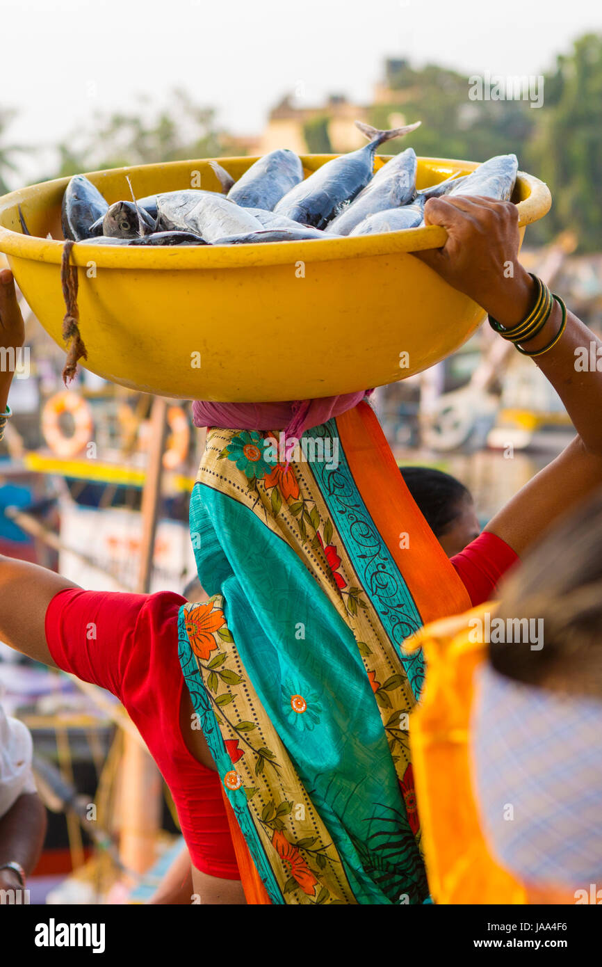 A woman carrying a bowl of fresh fish on her head, Sassoon dock fish ...