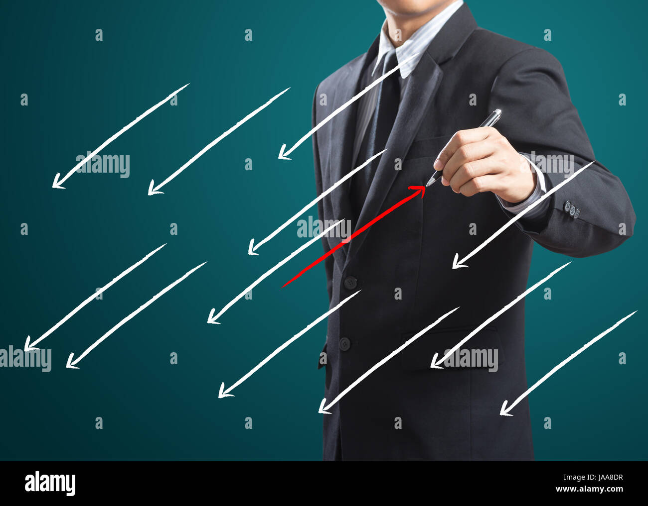 Businessman drawing arrows in different directions Stock Photo - Alamy