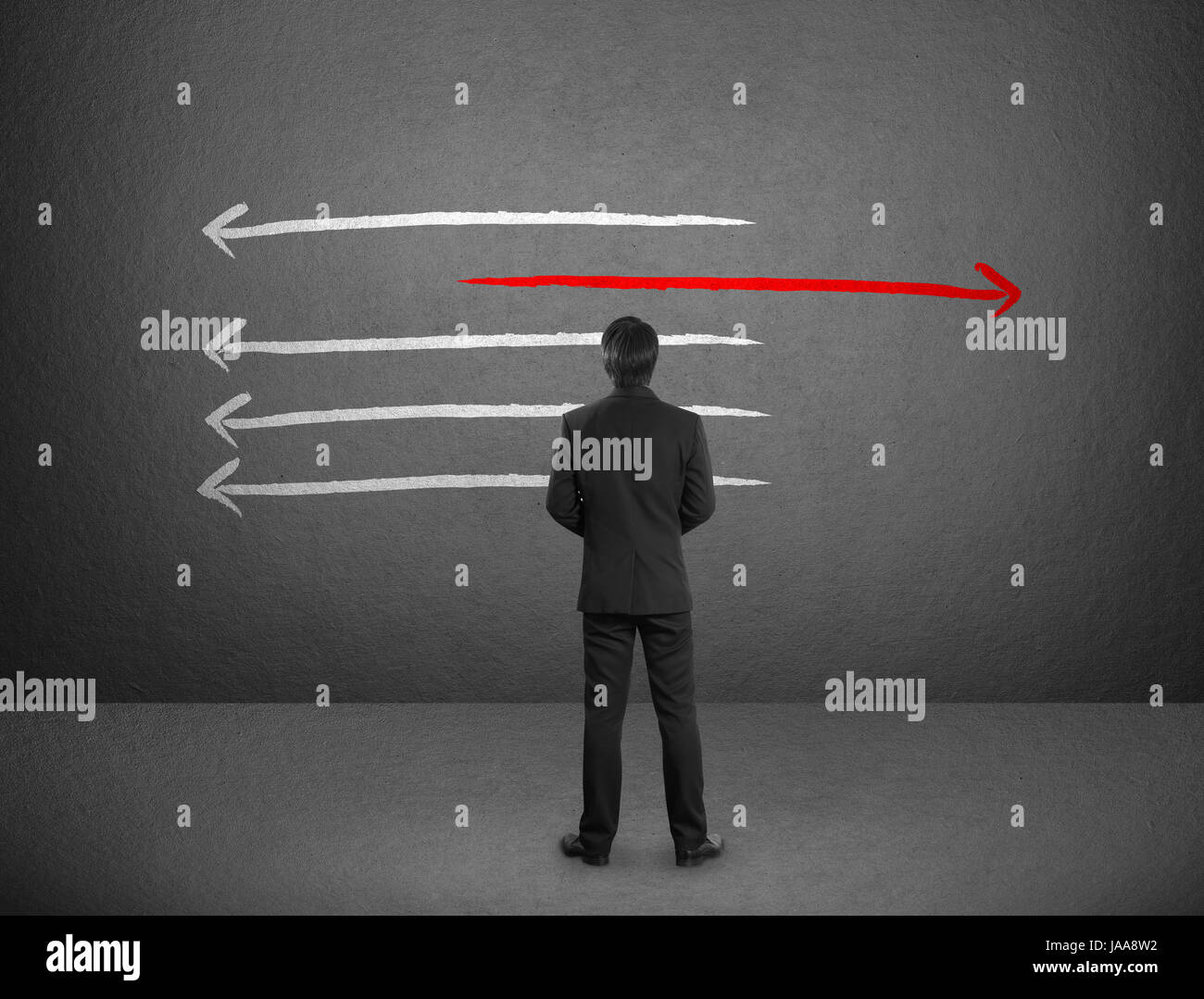 Businessman drawing arrows in different directions Stock Photo - Alamy