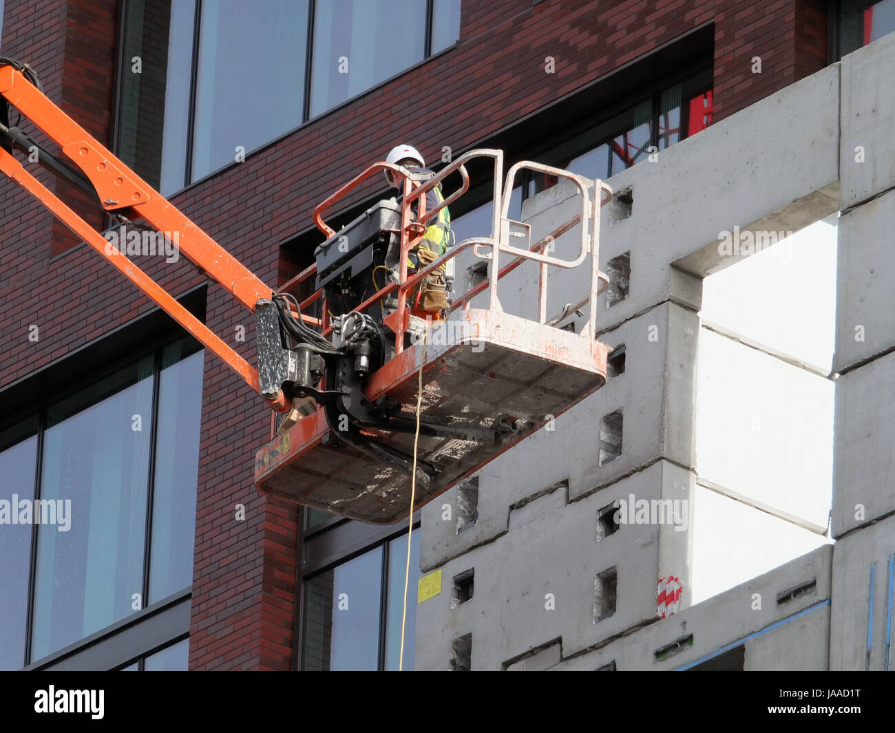 worker on an elevated construction platform on modern building ...