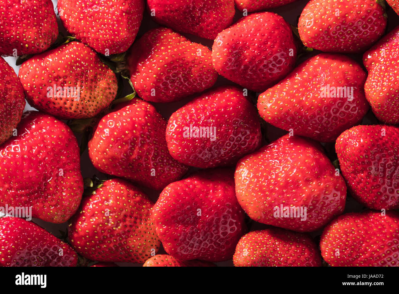 Berry background from a fresh strawberry texture closeup Stock Photo ...