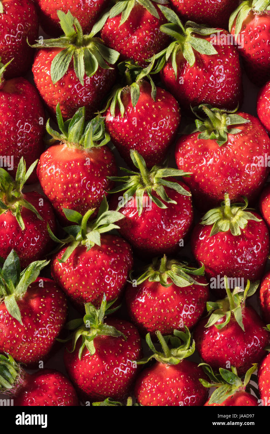 Berry background from a fresh strawberry texture closeup Stock Photo ...