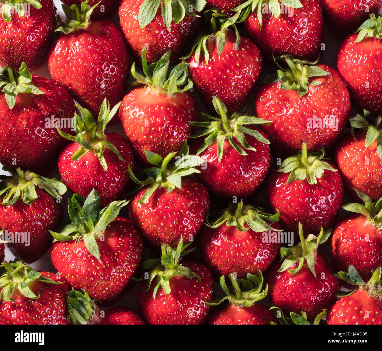 Berry background from a fresh strawberry texture closeup Stock Photo ...