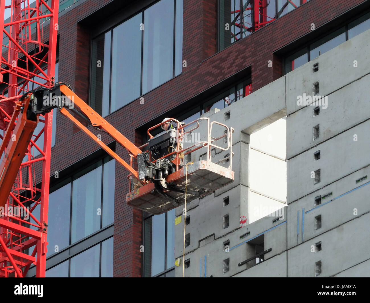 worker on an elevated construction platform on modern building ...