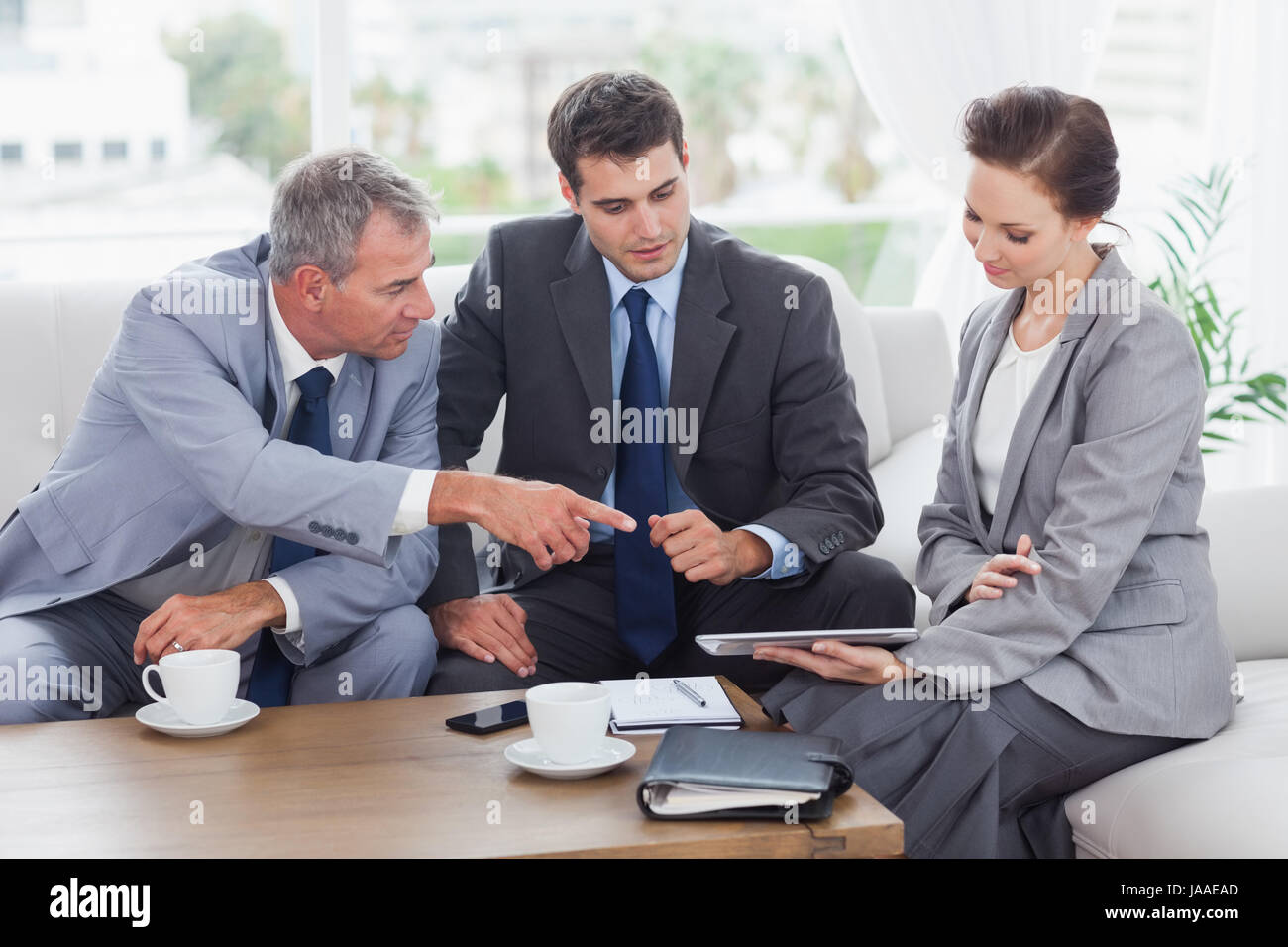 Work team having a meeting together in bright office Stock Photo - Alamy