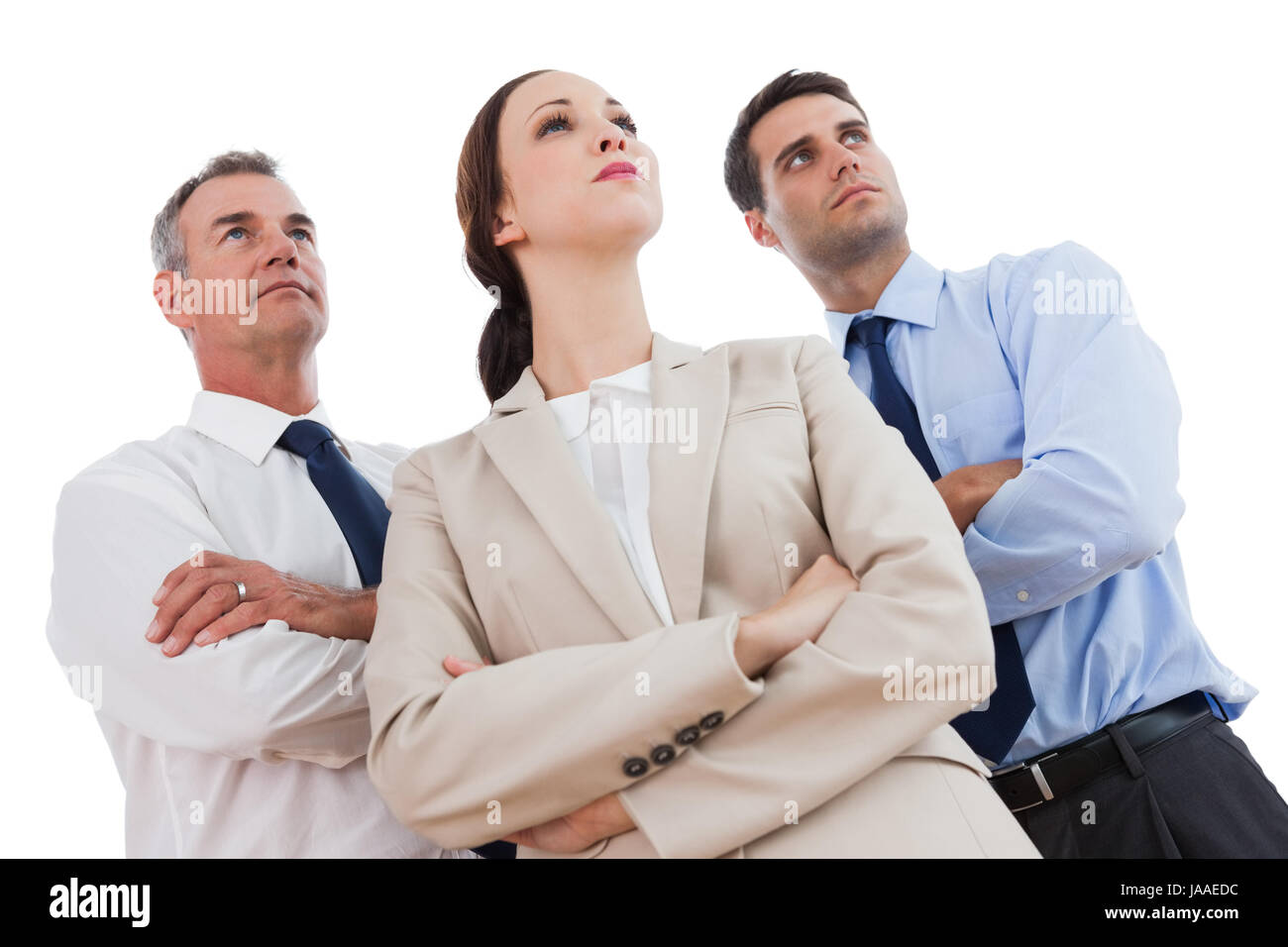 Serious work team posing together looking away on white background ...
