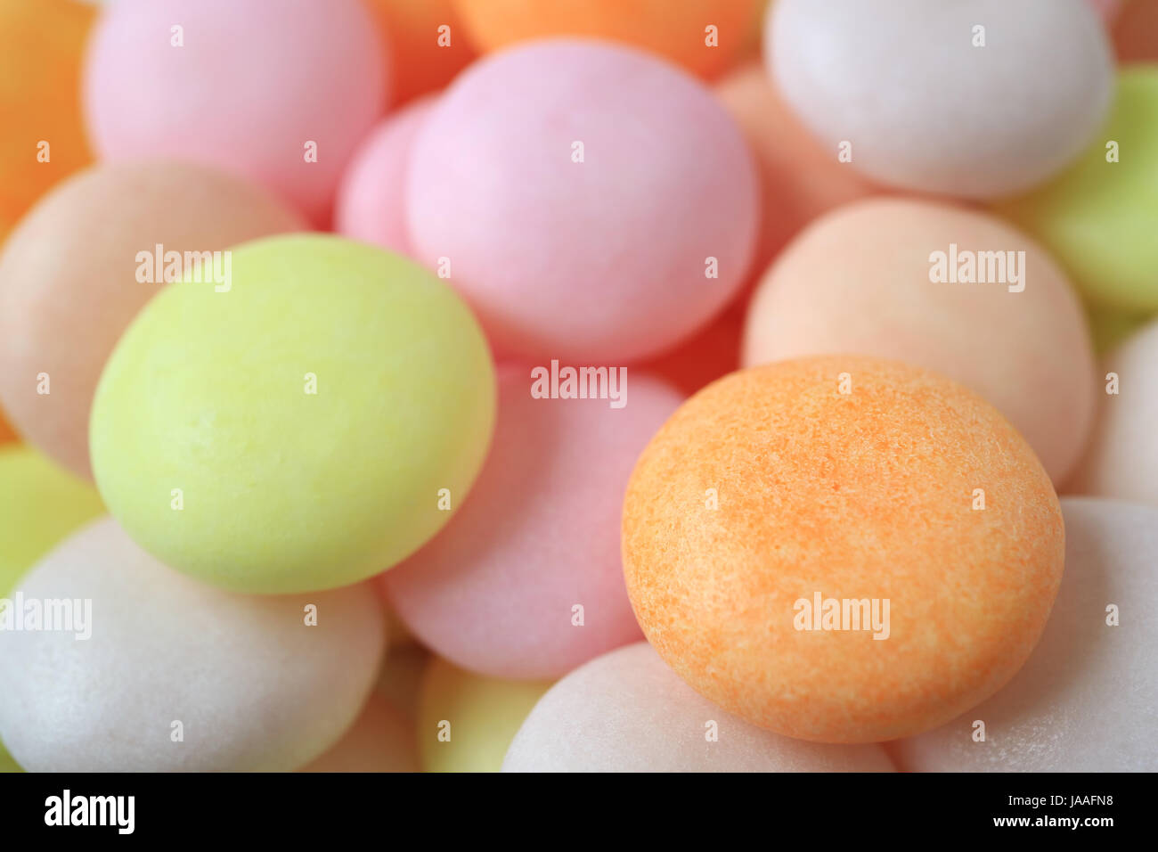 Closed up heap of pastel colored round shaped candy, for background ...