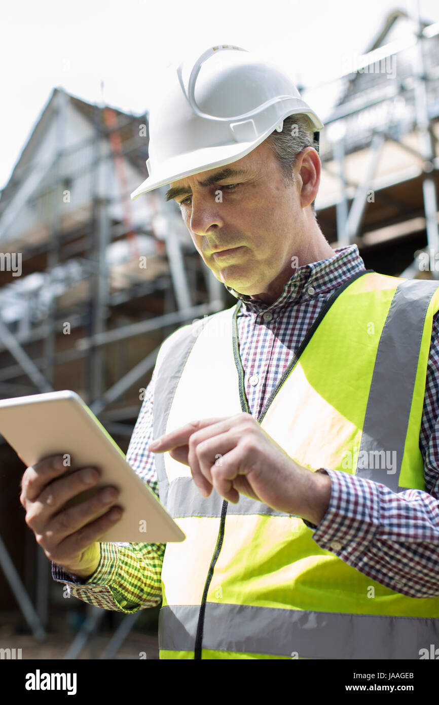 Architect On Building Site Using Digital Tablet Stock Photo - Alamy