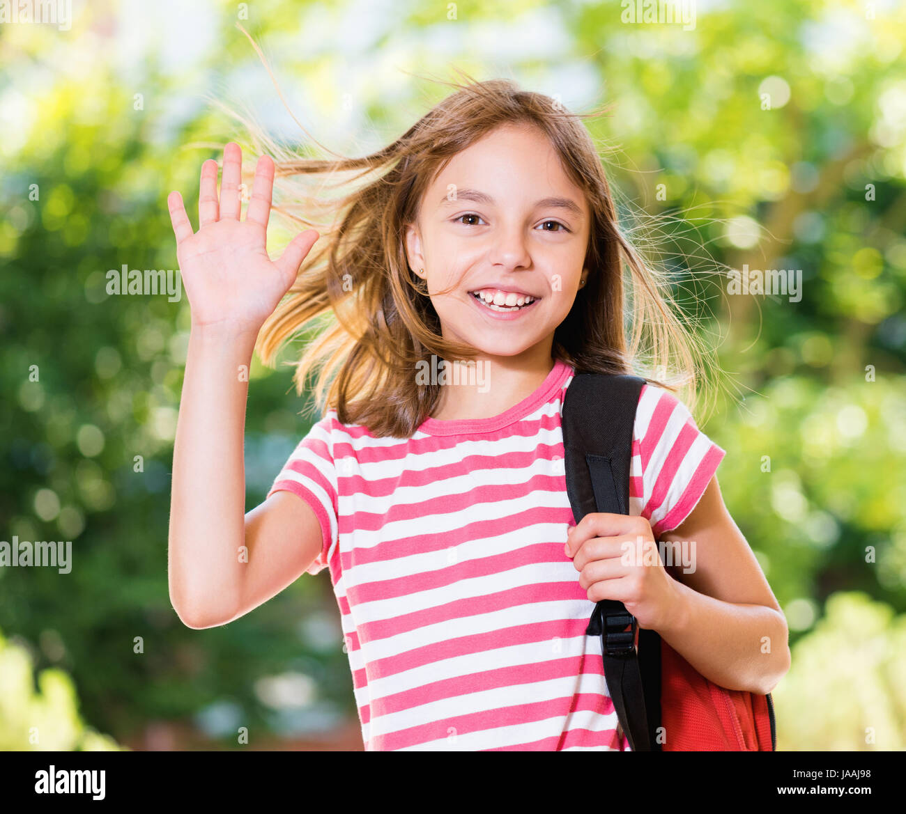 Girl with backpack posing outdoors Stock Photo - Alamy