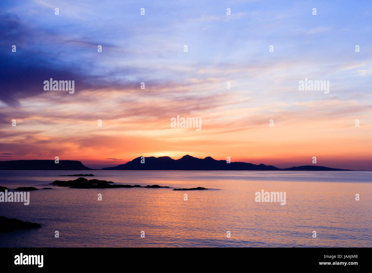 Eigg and Rhum from Camusdarach at sunset Stock Photo - Alamy