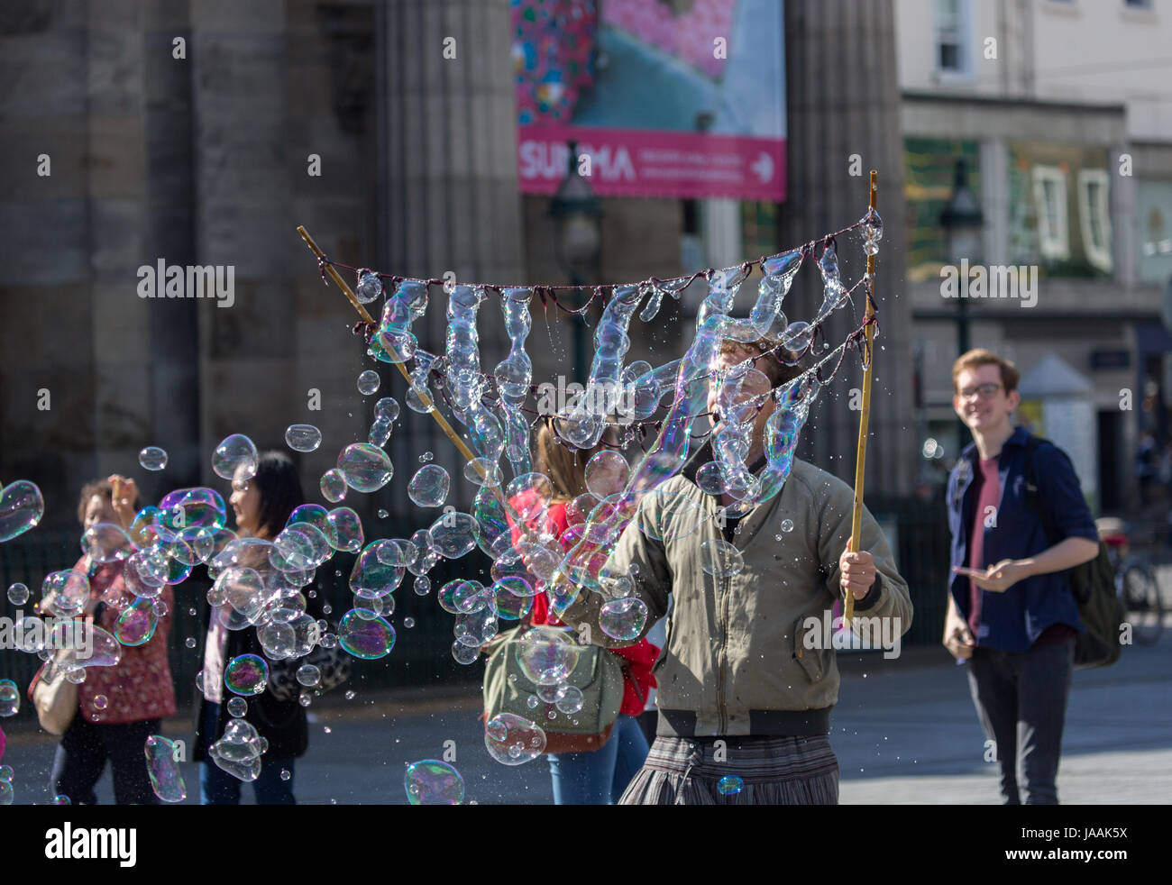 A street entertainer in Edinburgh blowing bubbles Stock Photo - Alamy
