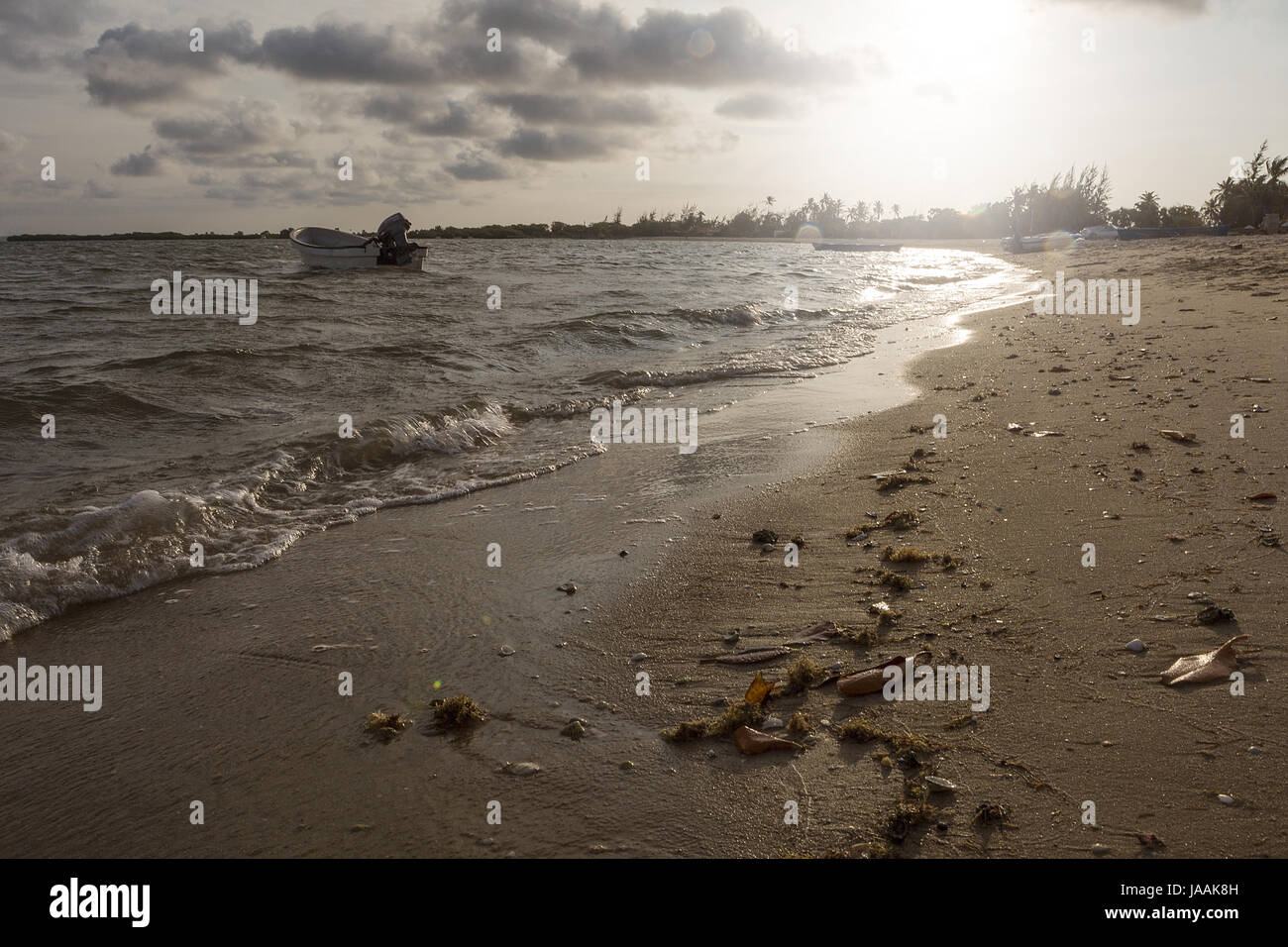 Sunset on the tropical island of mussulo angola with fishing boats ...