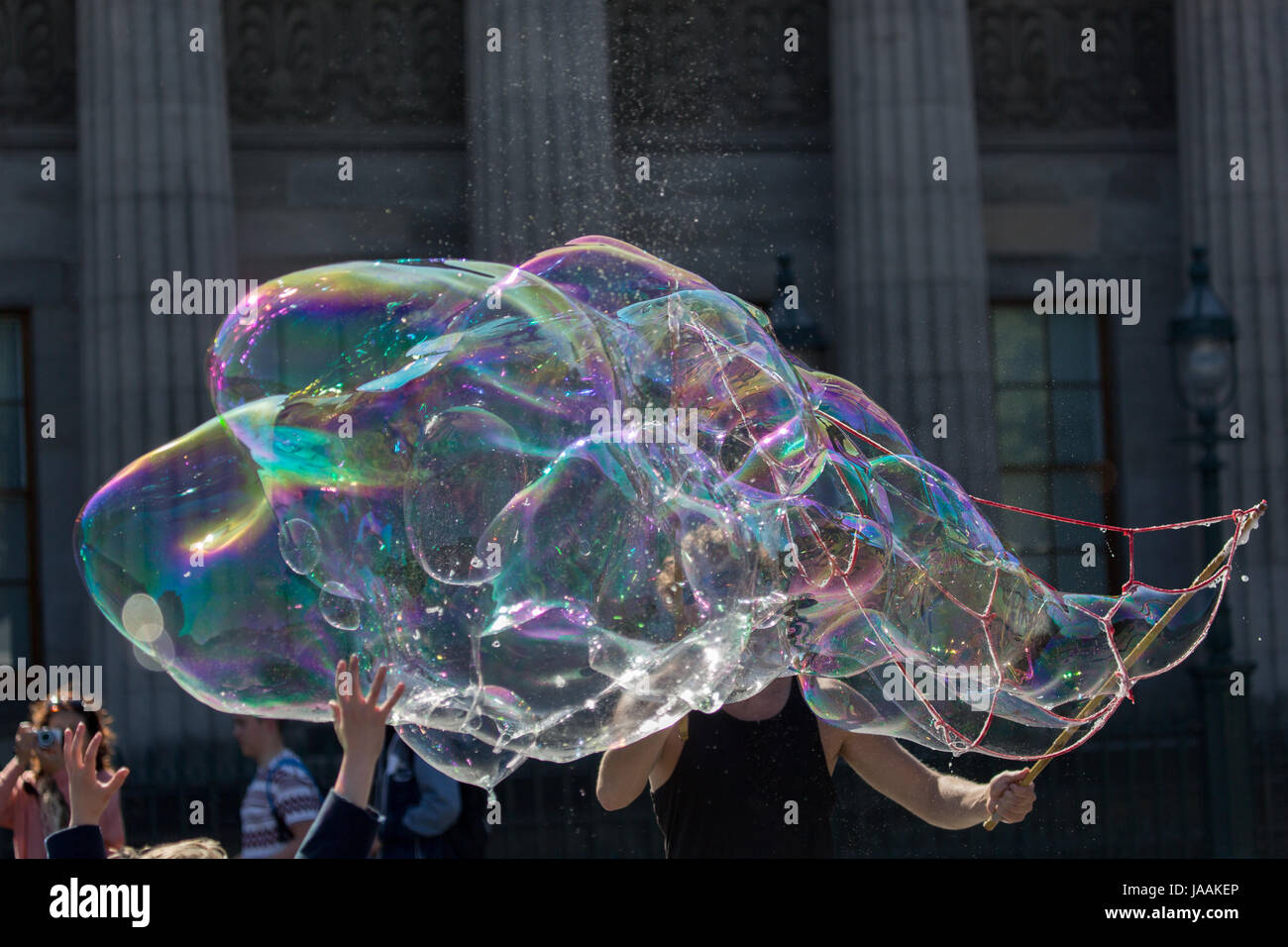 A street entertainer in Edinburgh blowing bubbles Stock Photo - Alamy