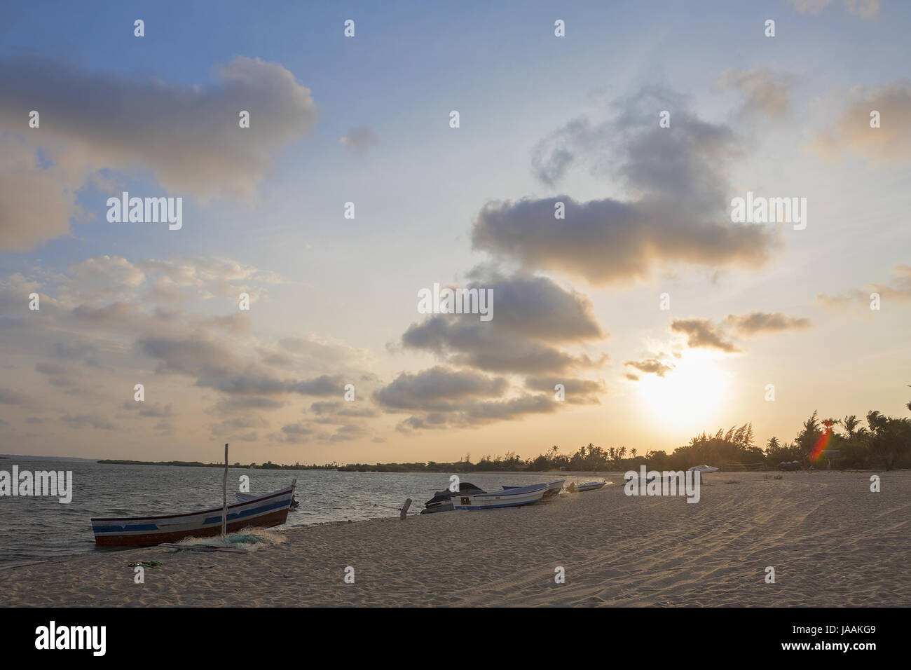 Sunset on the tropical island of mussulo angola with fishing boats ...