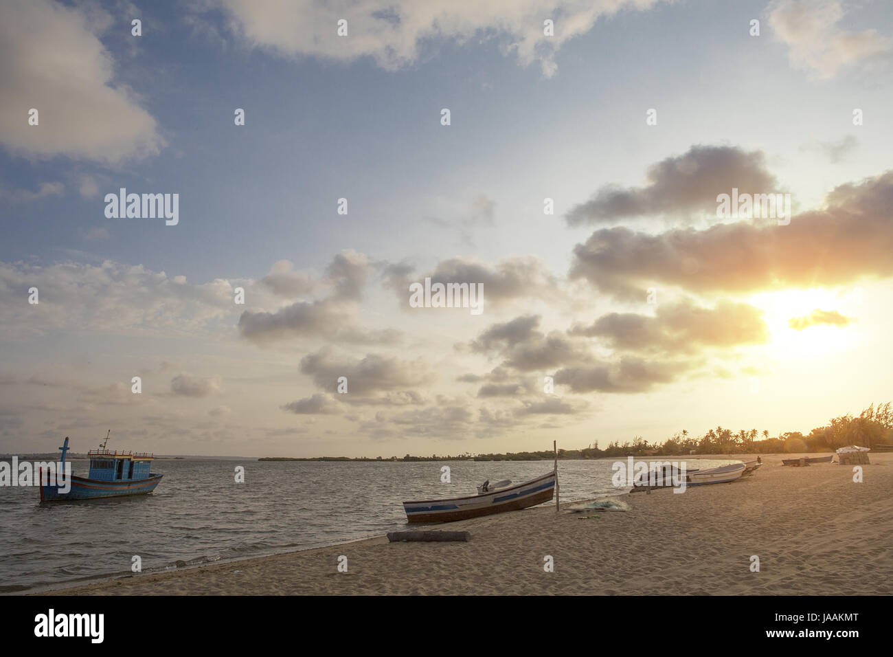 Sunset on the tropical island of mussulo angola with fishing boats ...