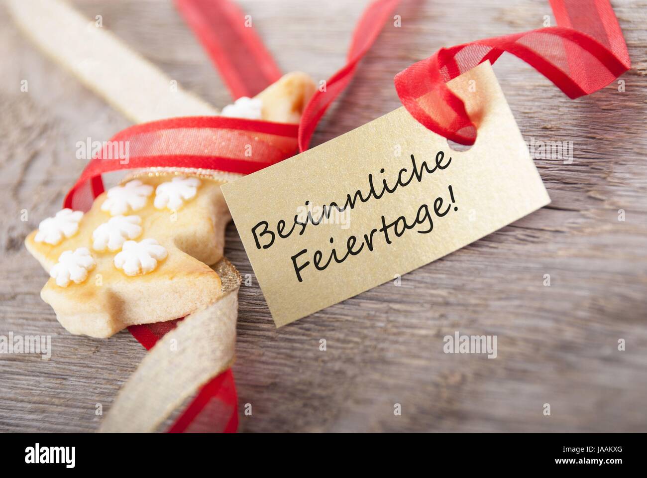 a golden tag with the german words Besinnliche Feiertage which means ...