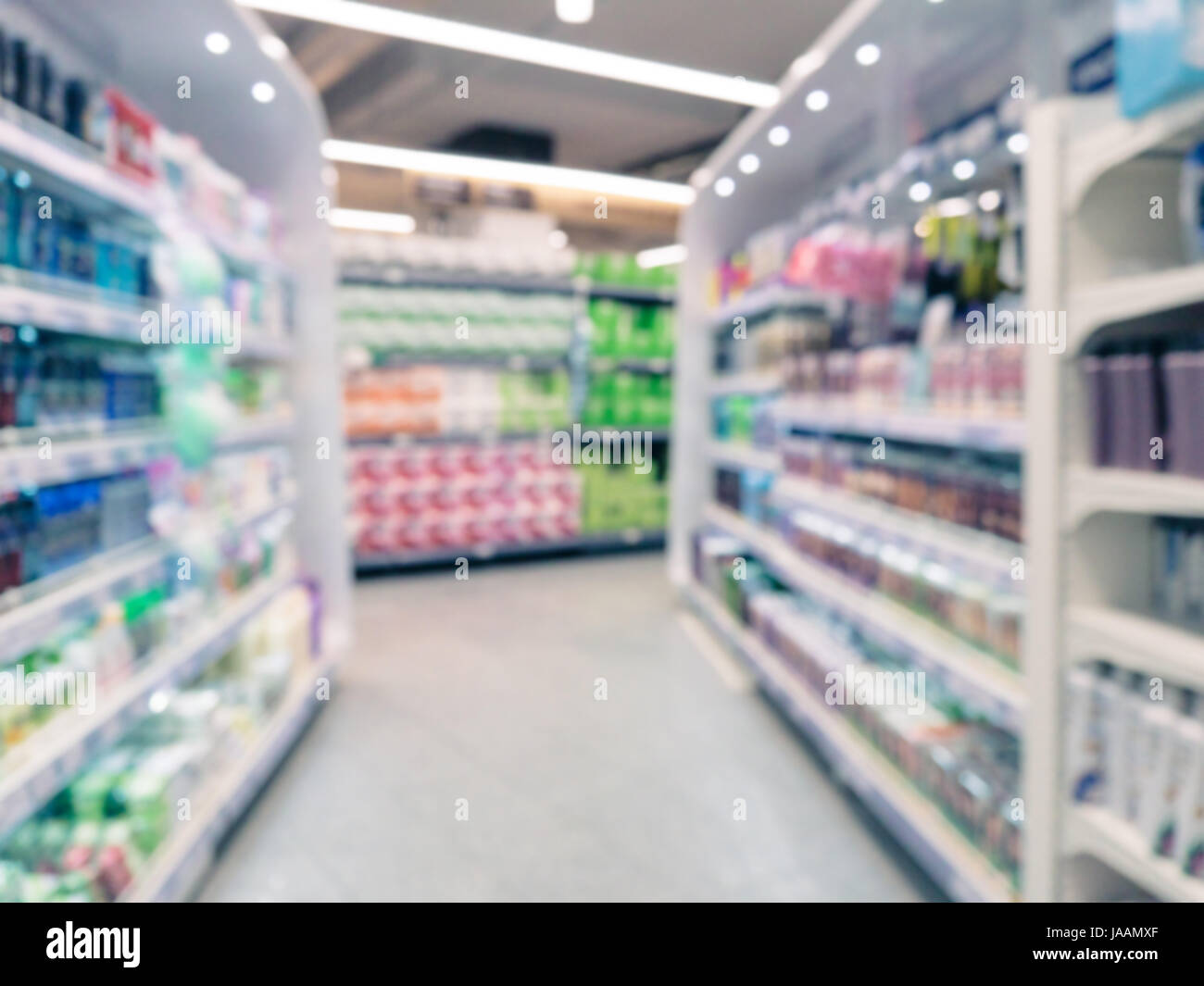 Abstract blurred supermarket aisle with colorful shelves and ...