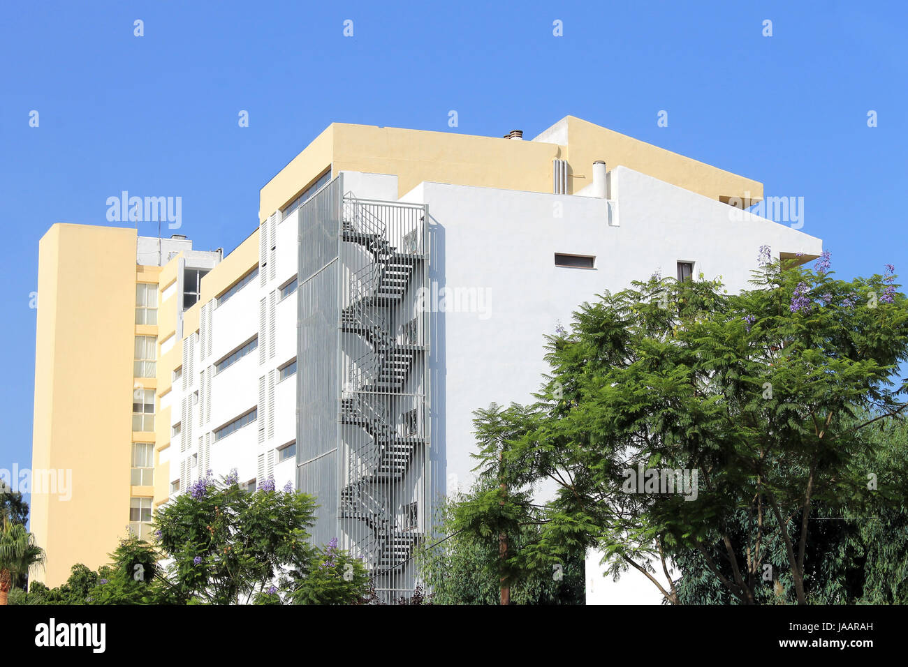 Side view of hotel building with blue sky background Stock Photo - Alamy
