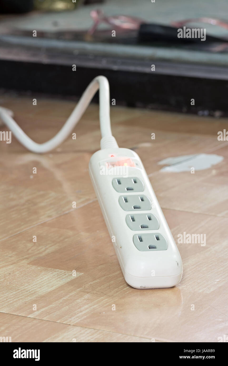 White power strip or extension block laying on the floor Stock Photo ...