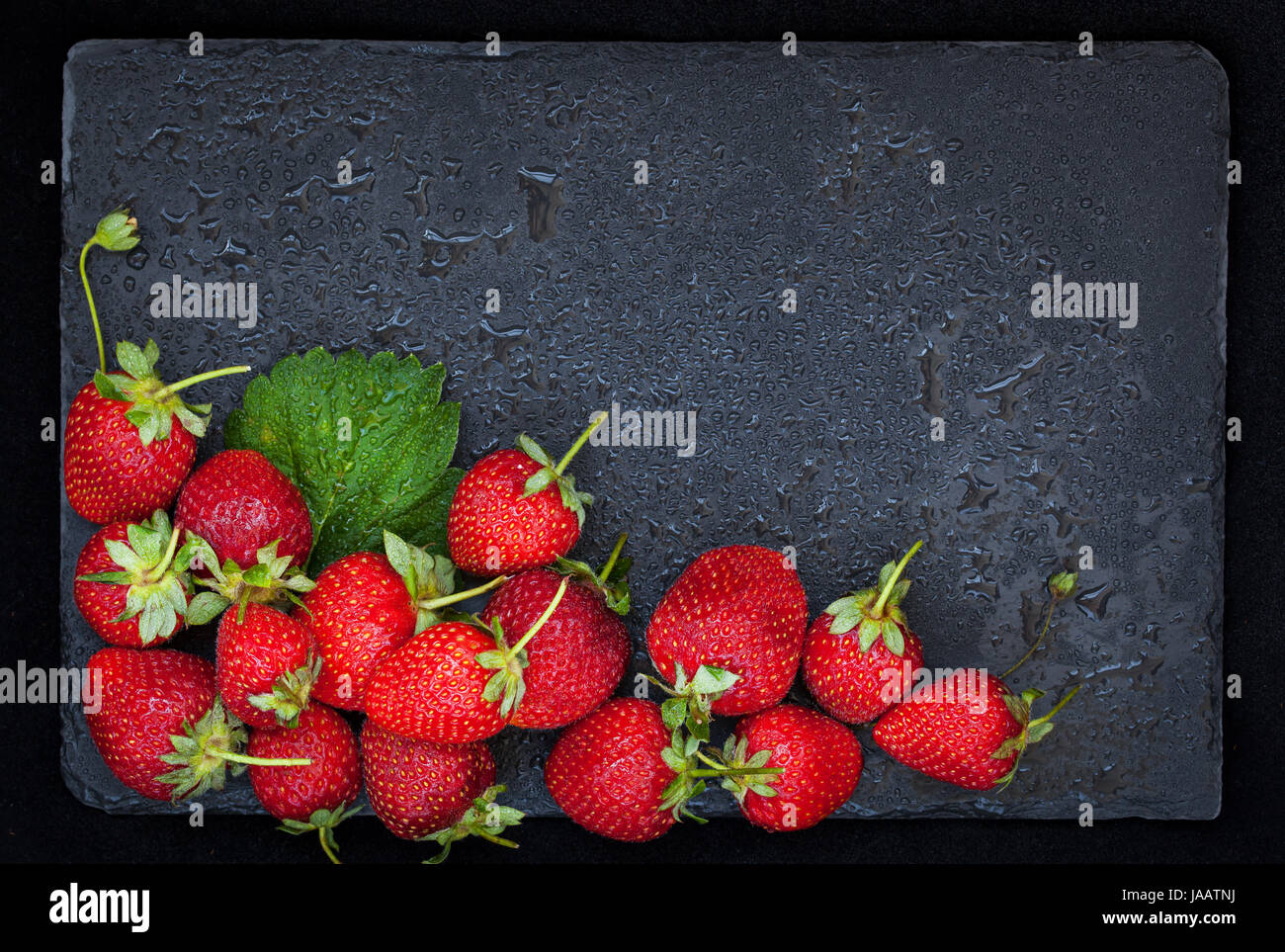 Fresh ripe strawberry on dark background with empty space (copy space ...