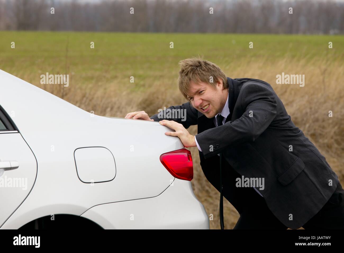 Pushing a broken down car Stock Photo - Alamy