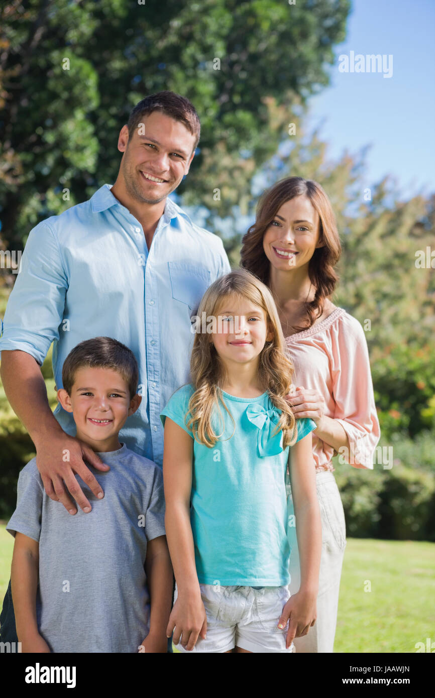 Happy family standing in the countryside smiling at camera Stock Photo ...