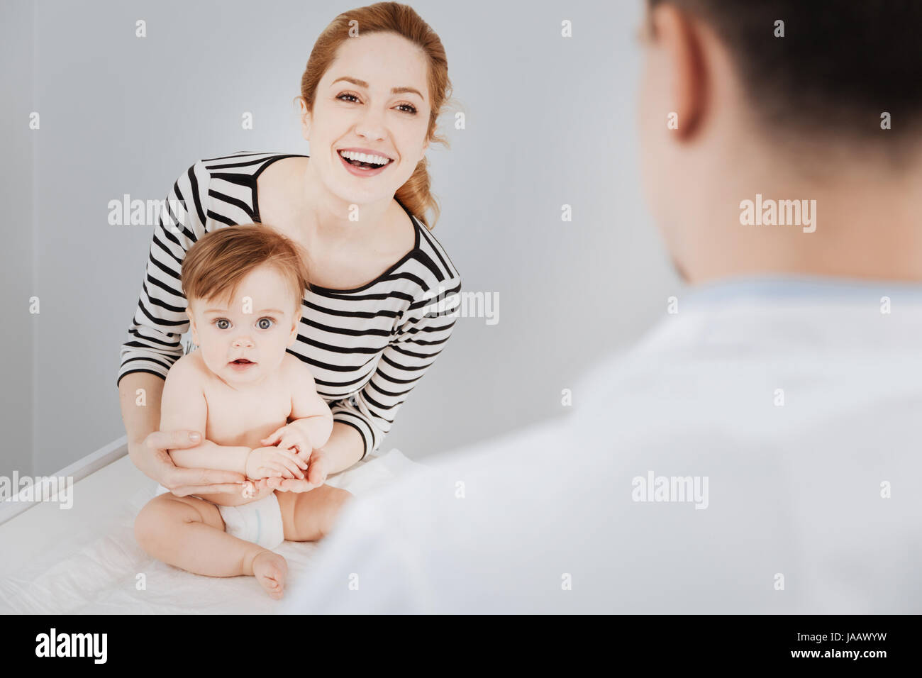 New friend. Positive gentle protective mom and her kid waiting for a ...