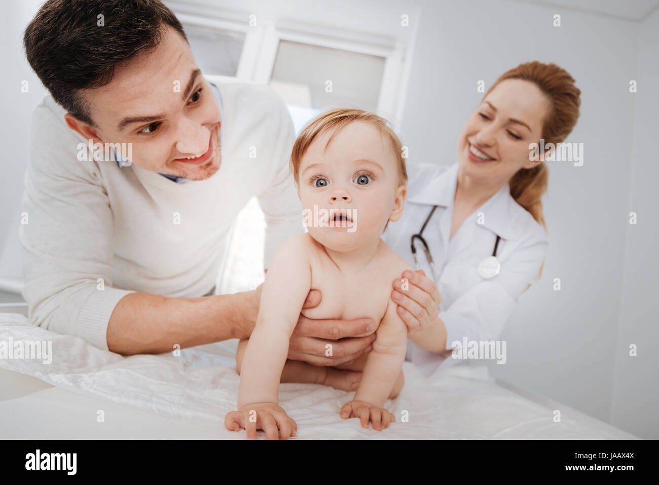 Next generation. Cool fun handsome parent making sure his child ...