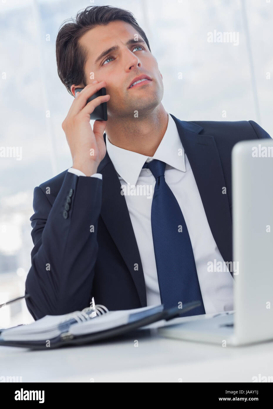 Stern businessman smartphone hi-res stock photography and images - Alamy