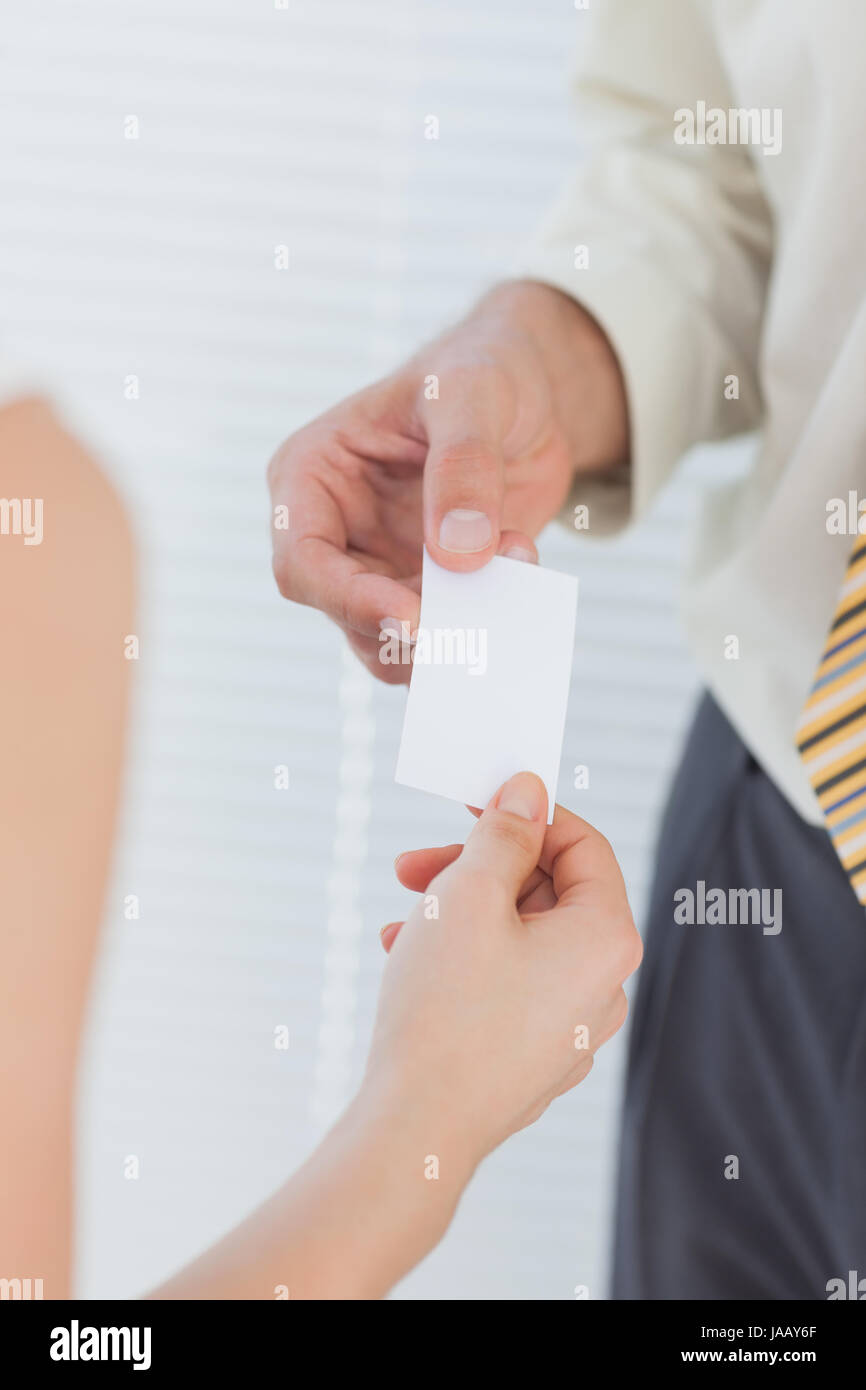 Businessman giving his business card in bright office Stock Photo - Alamy