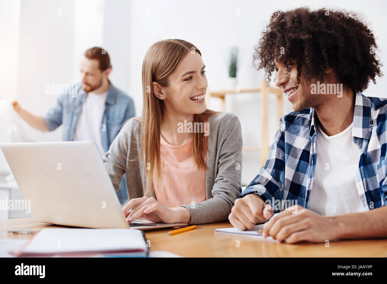 Sharing ideas. Bright committed cheerful people sitting in the office ...