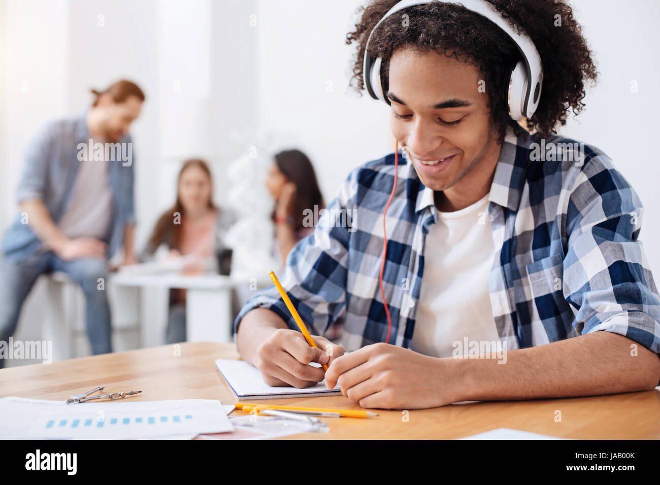 Sound of productivity. Nice observant young man writing down his ideas ...