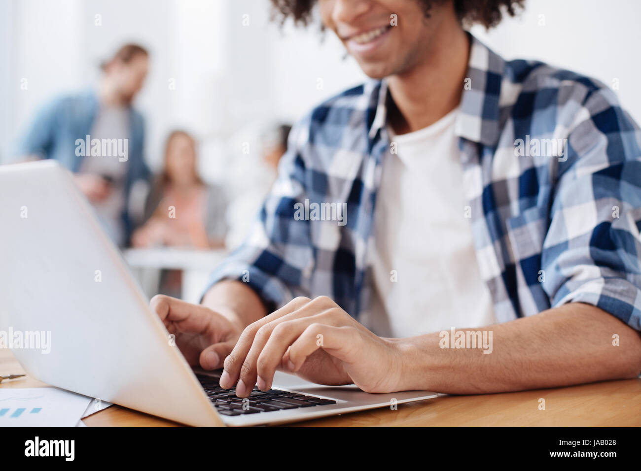 Instant chat. Cheerful clever friendly man using his computer for ...