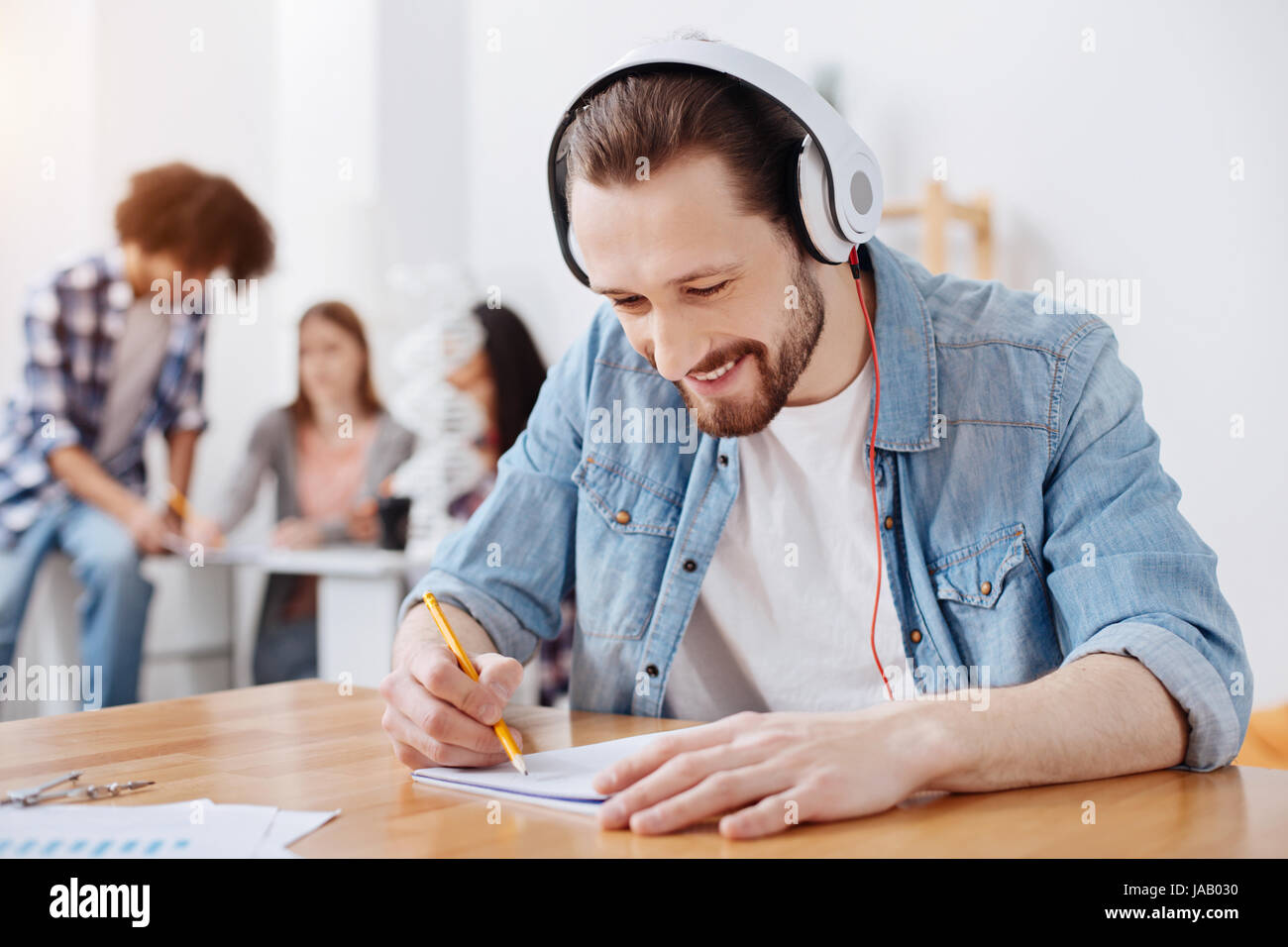 Enjoying the process. Delighted admirable friendly guy wearing ...