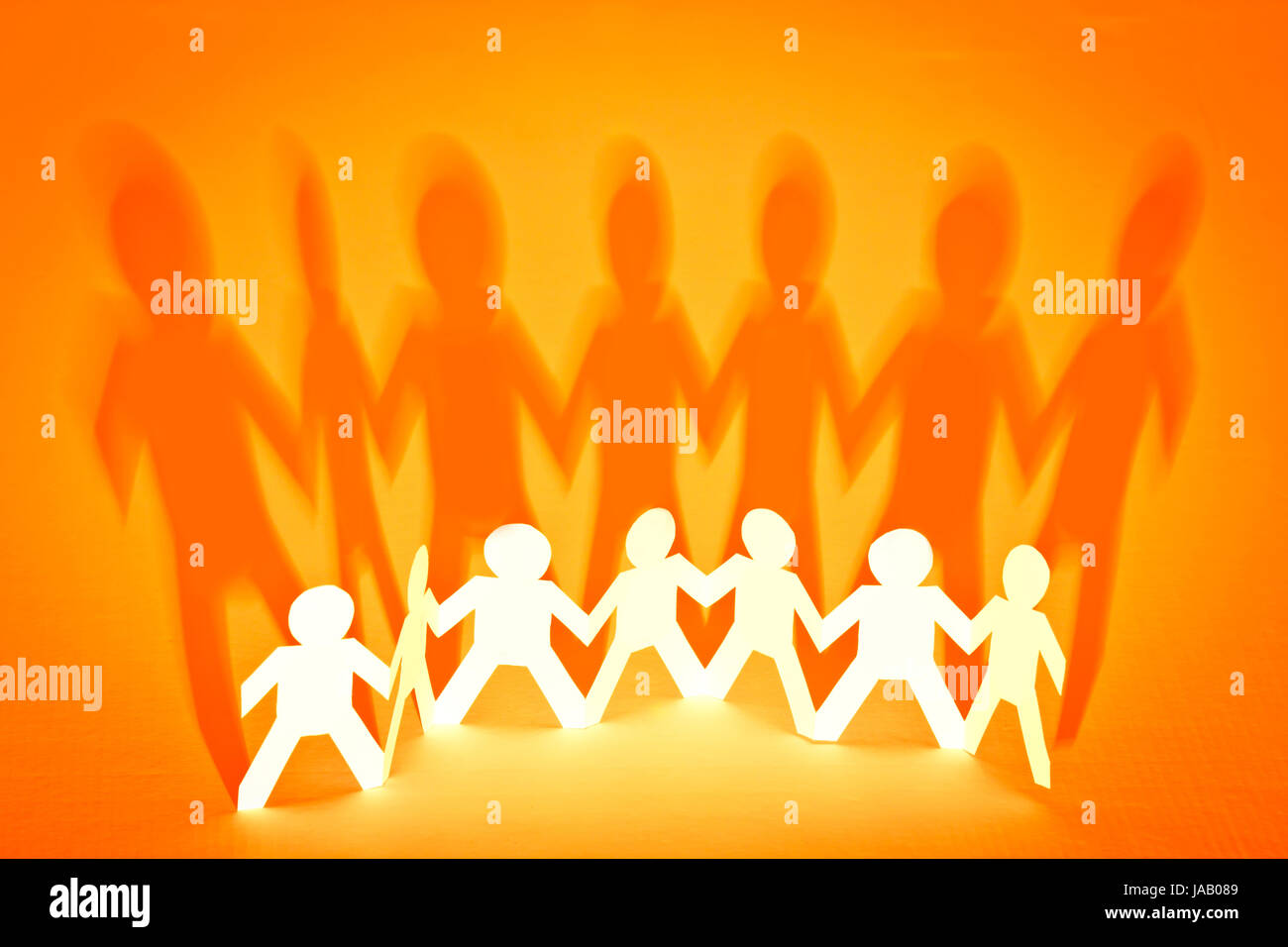 Paper people holding hands Stock Photo - Alamy