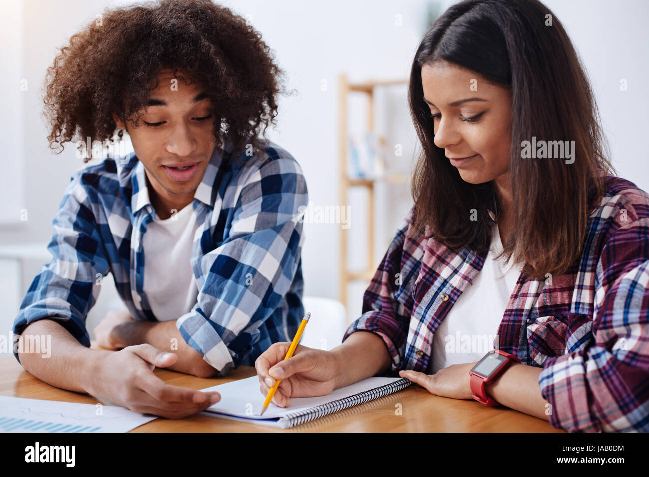 Helping each other. Handsome intelligent nice man assisting his friend ...