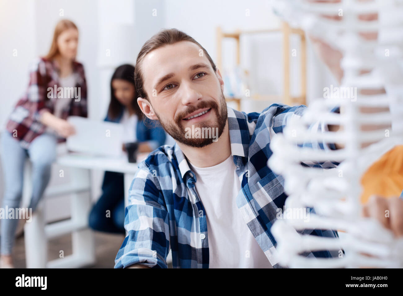 Inspired young scientist. Vibrant engaged clever man examining the ...