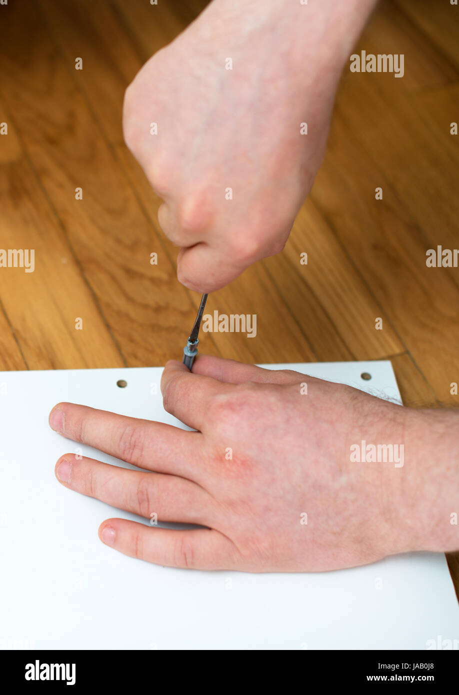 Man's hand using screwdriver. Close-up view Stock Photo - Alamy