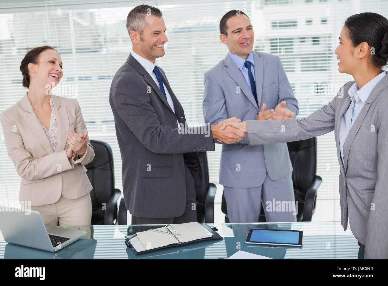 Smiling workmates working together hi-res stock photography and images ...