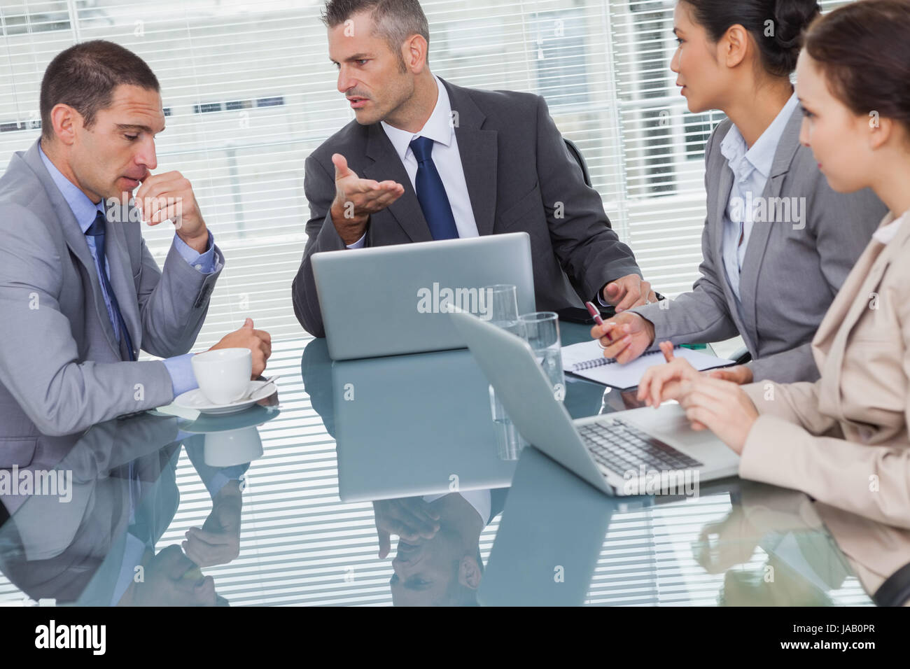 Business people interacting and working together in bright office Stock ...