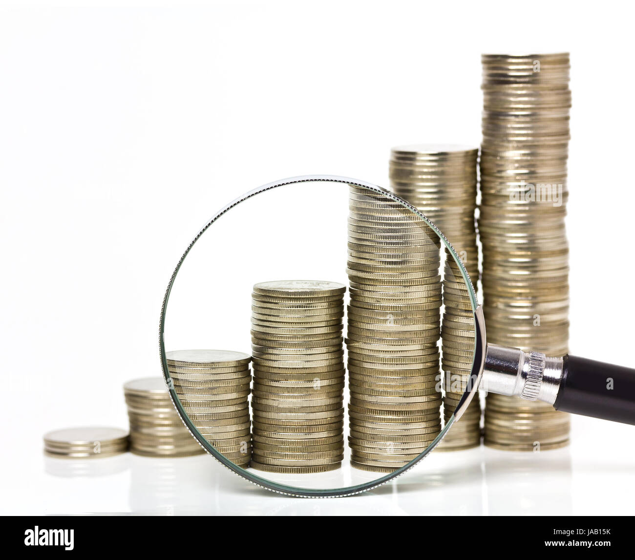 coins stacks with magnifying glass Stock Photo - Alamy