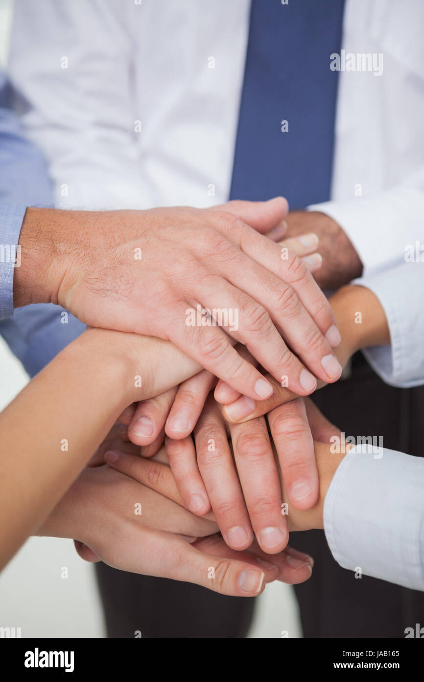 Close up on work teams hands all together in bright office Stock Photo ...