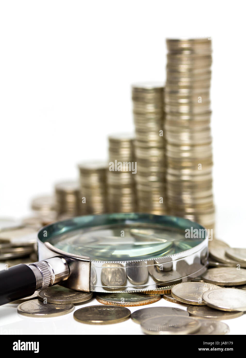 coins stacks with magnifying glass Stock Photo - Alamy