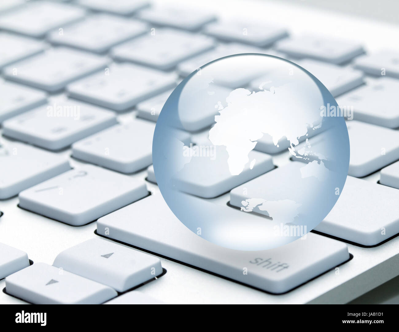 Globe on a keyboard laptop Stock Photo - Alamy