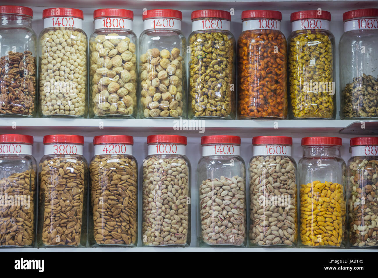 Different kinds of nuts for sale in plastic jars Stock Photo - Alamy